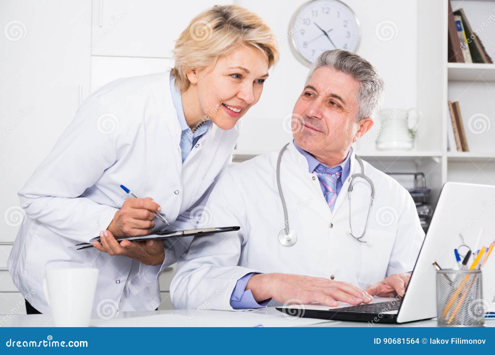 Doctor and Nurse Reading Information Stock Photo - Image of ...