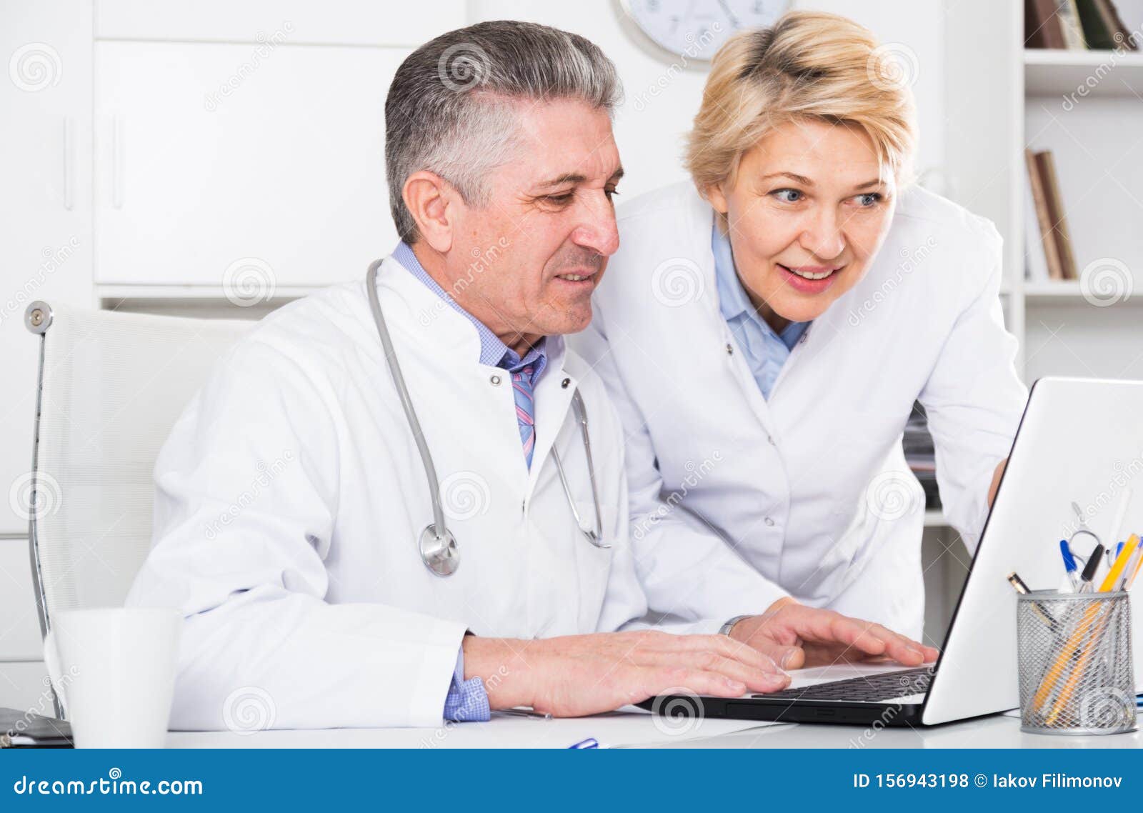 Doctor and Nurse Reading Information Stock Photo - Image of information ...