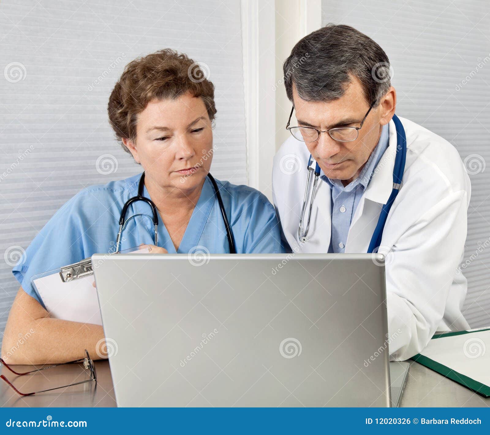 Doctor and Nurse Reviewing on Laptop Computer in O Stock Photo - Image ...