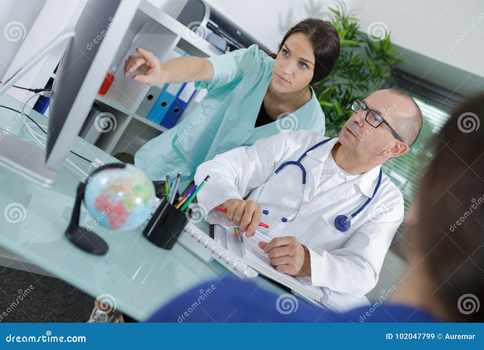 Doctor and Nurse Use Computer Stock Image - Image of point, desk: 102047799