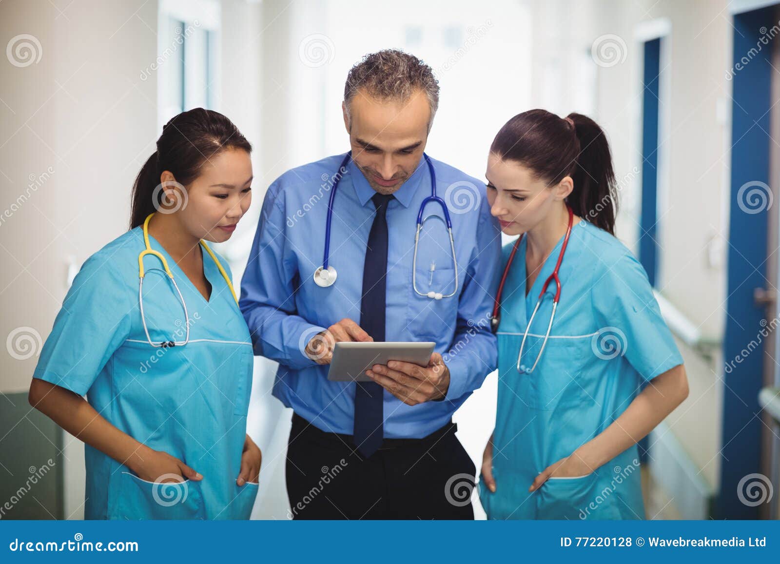 Doctor and Nurses Discussing Over Digital Tablet Stock Photo - Image of ...