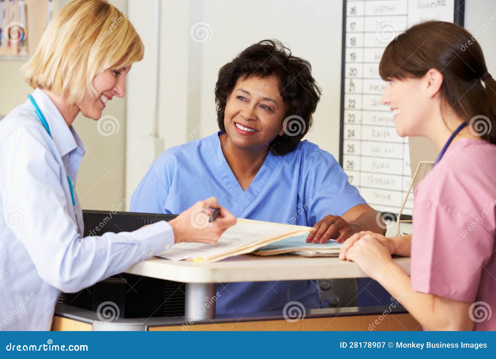 Doctor and Nurses in Discussion at Nurses Station Stock Image - Image ...