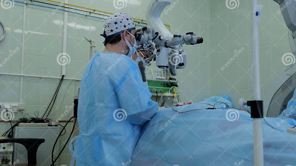 The Doctor Operates Using a Microscope during Nerve Surgery. the ...