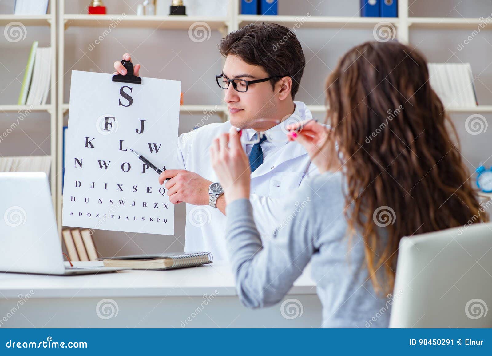 The Doctor Optician with Letter Chart Conducting an Eye Test Check ...