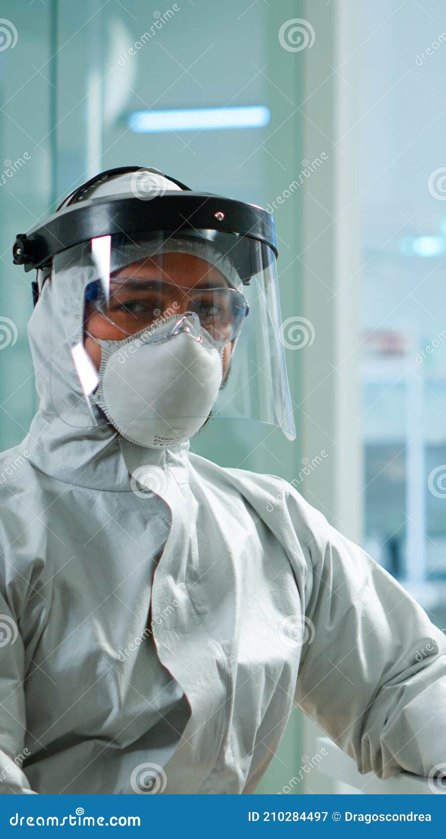 Doctor with Overall Suit Working at Computer and Looking at Camera ...