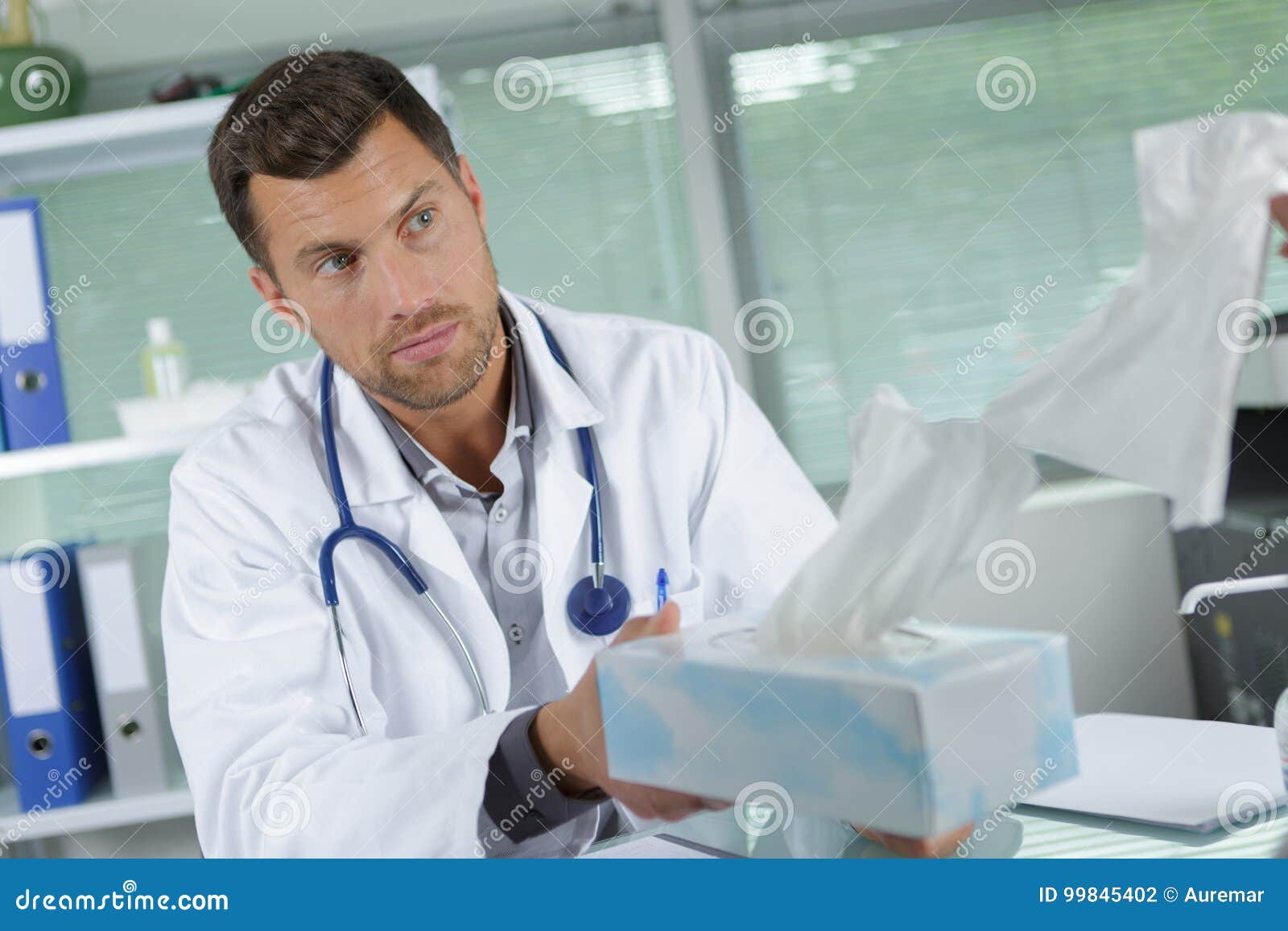 Doctor passing box tissues stock photo. Image of care - 99845402