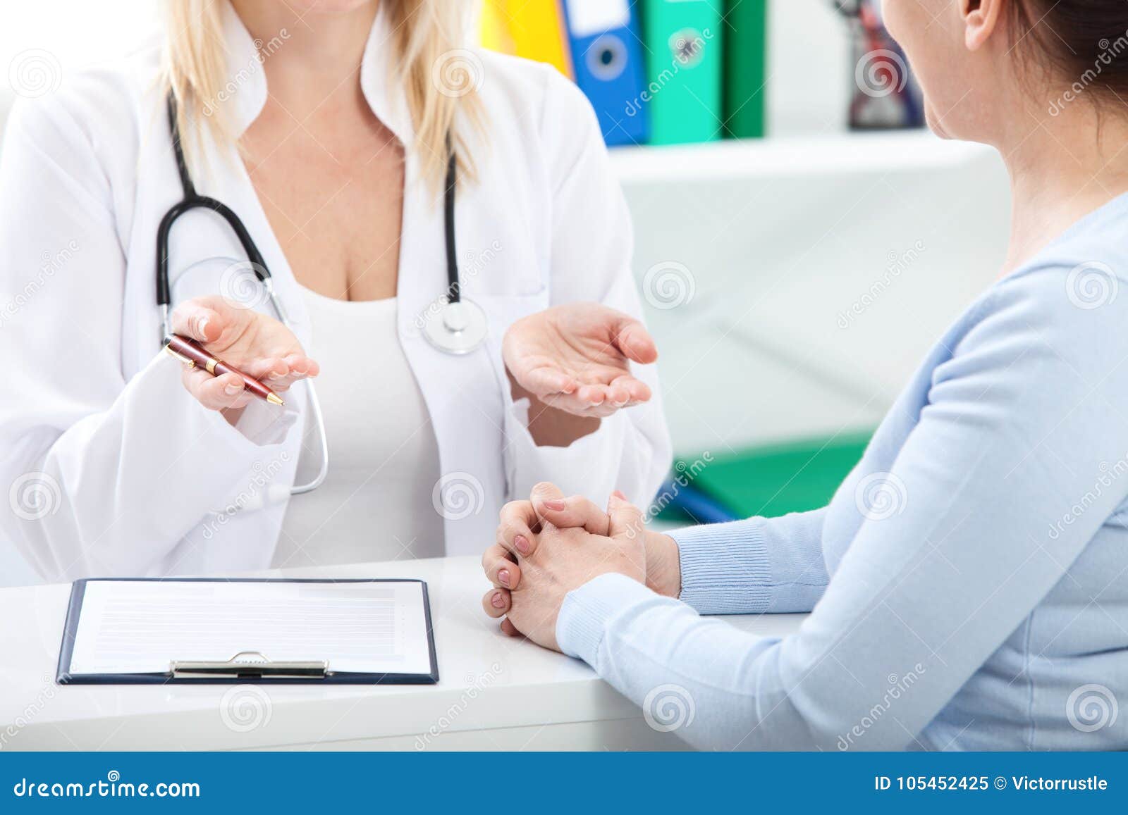 Doctor and Patient are Discussing Something, Just Hands at the Table ...