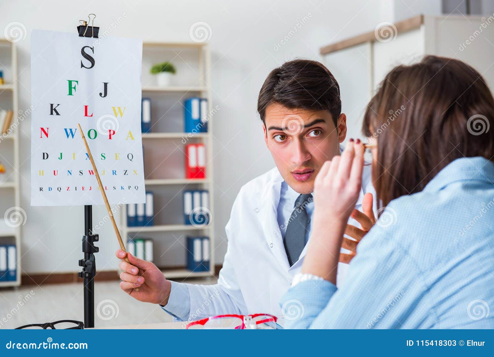 The Doctor with Patient at Eye Exam Stock Image - Image of chart ...