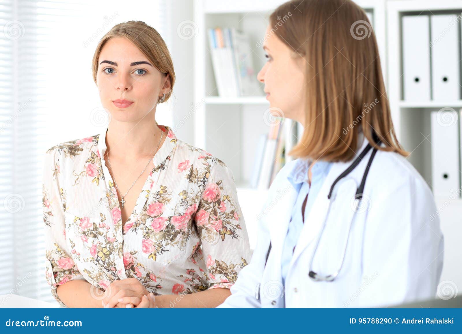 Doctor and Patient Sitting at the Desk Stock Photo - Image of ...