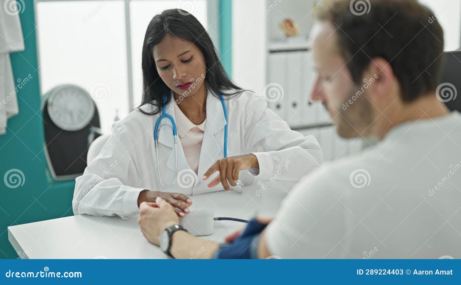 Doctor and Patient Sitting on Table Measuring Pulse Using Tensiometer ...