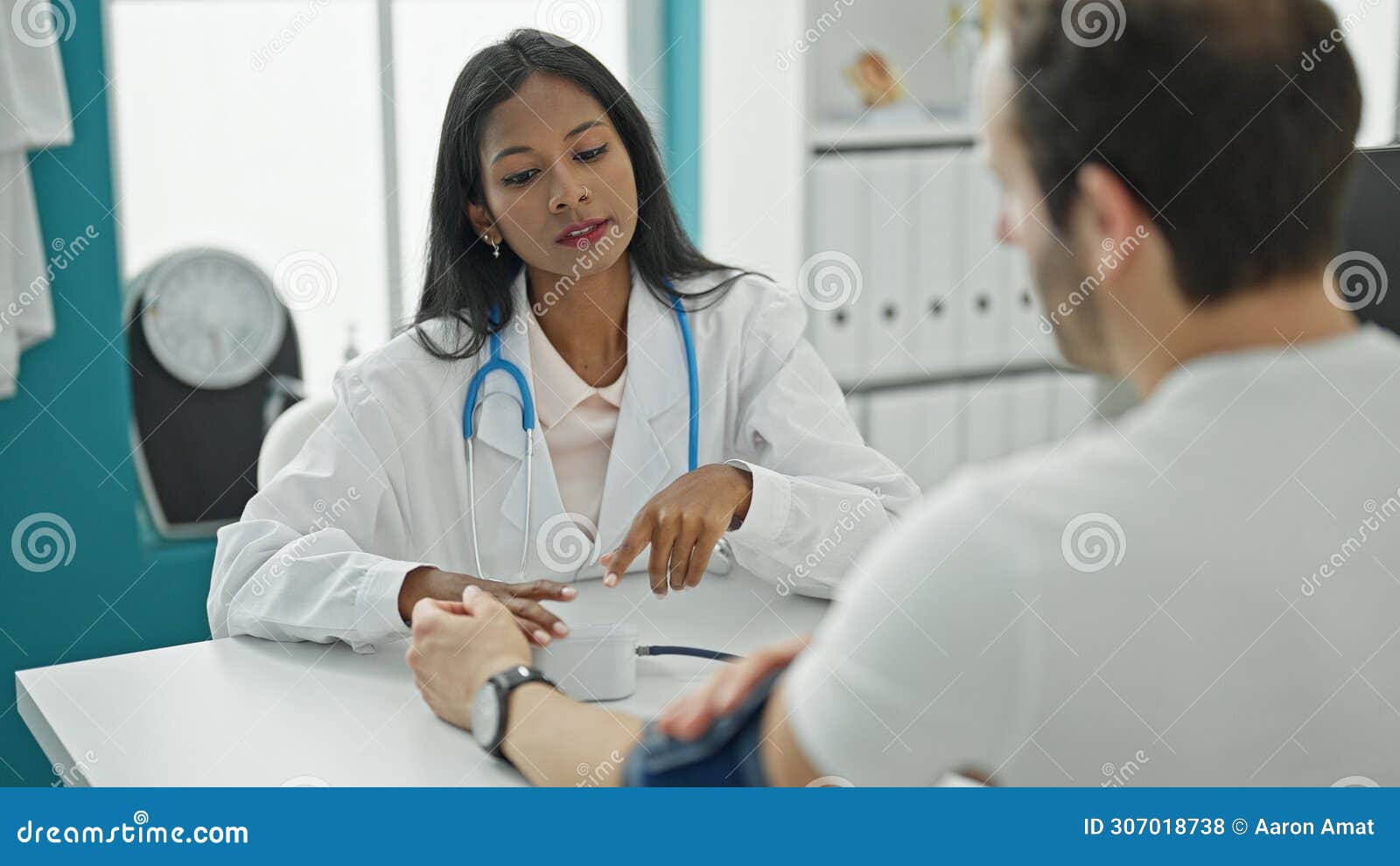 Doctor and Patient Sitting on Table Measuring Pulse Using Tensiometer ...