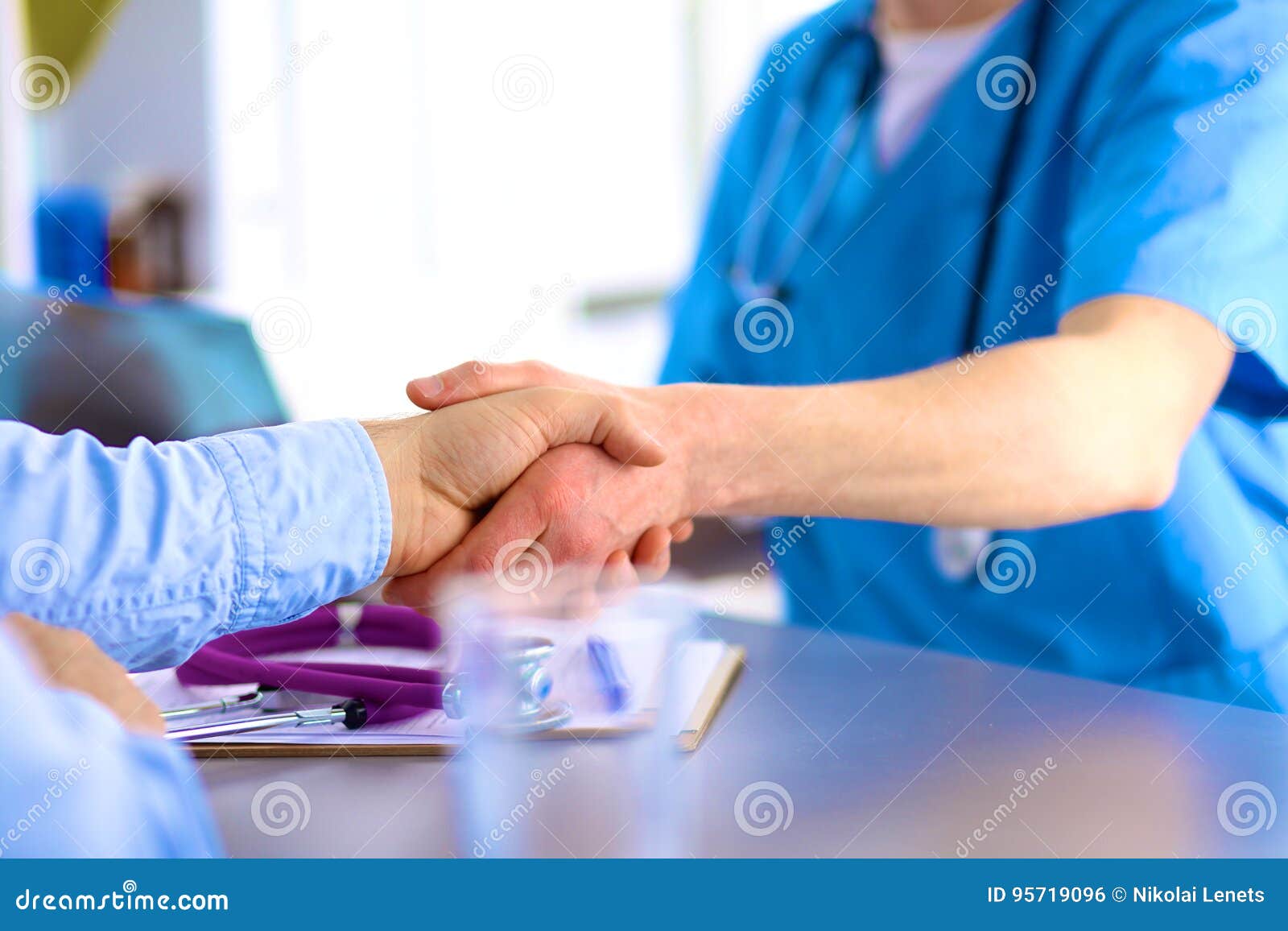 Doctor and Patient at the Table. Solution Stock Photo - Image of paper ...