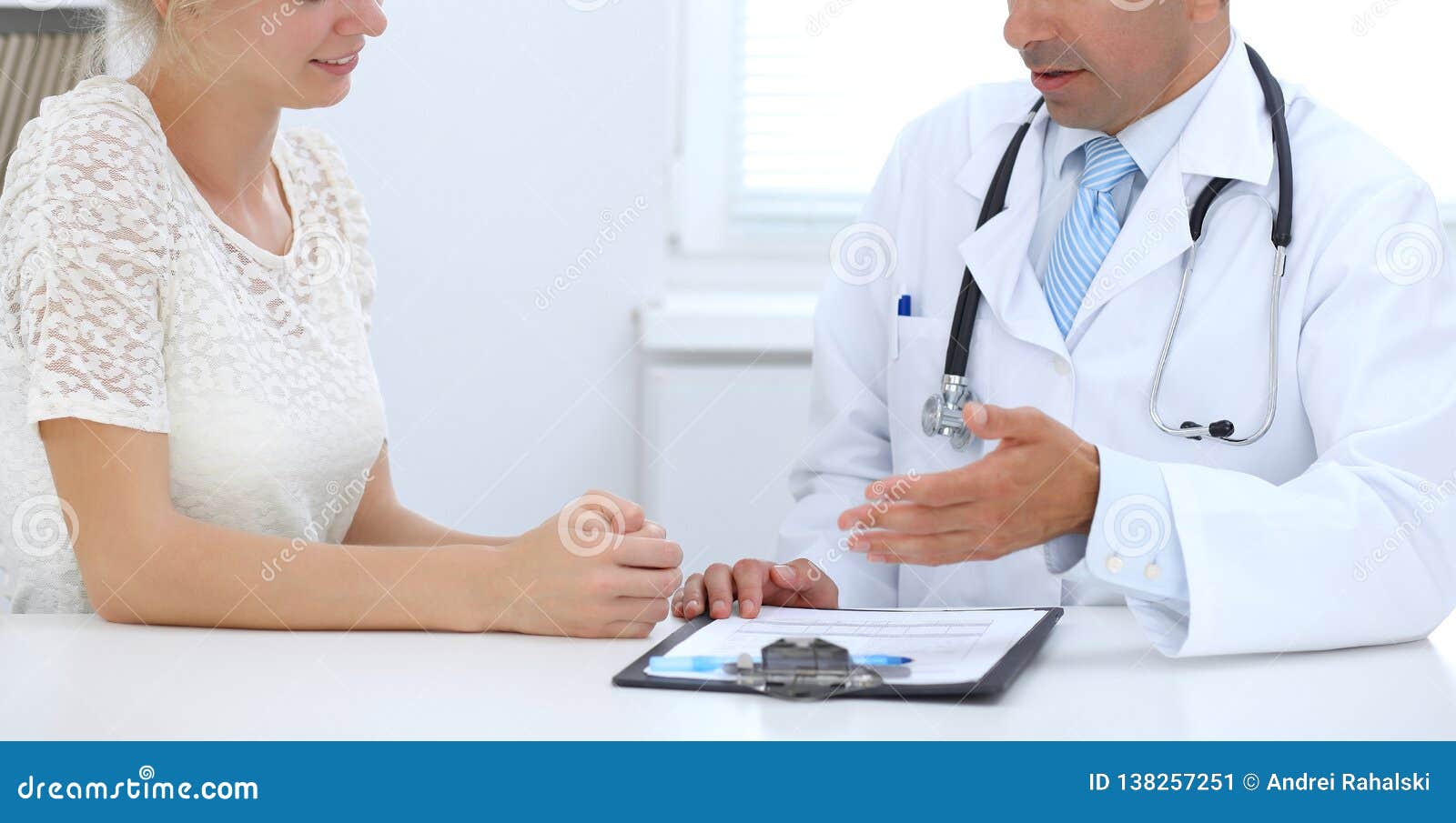 Doctor and Patient Talking while Sitting at the Table . Concept of ...