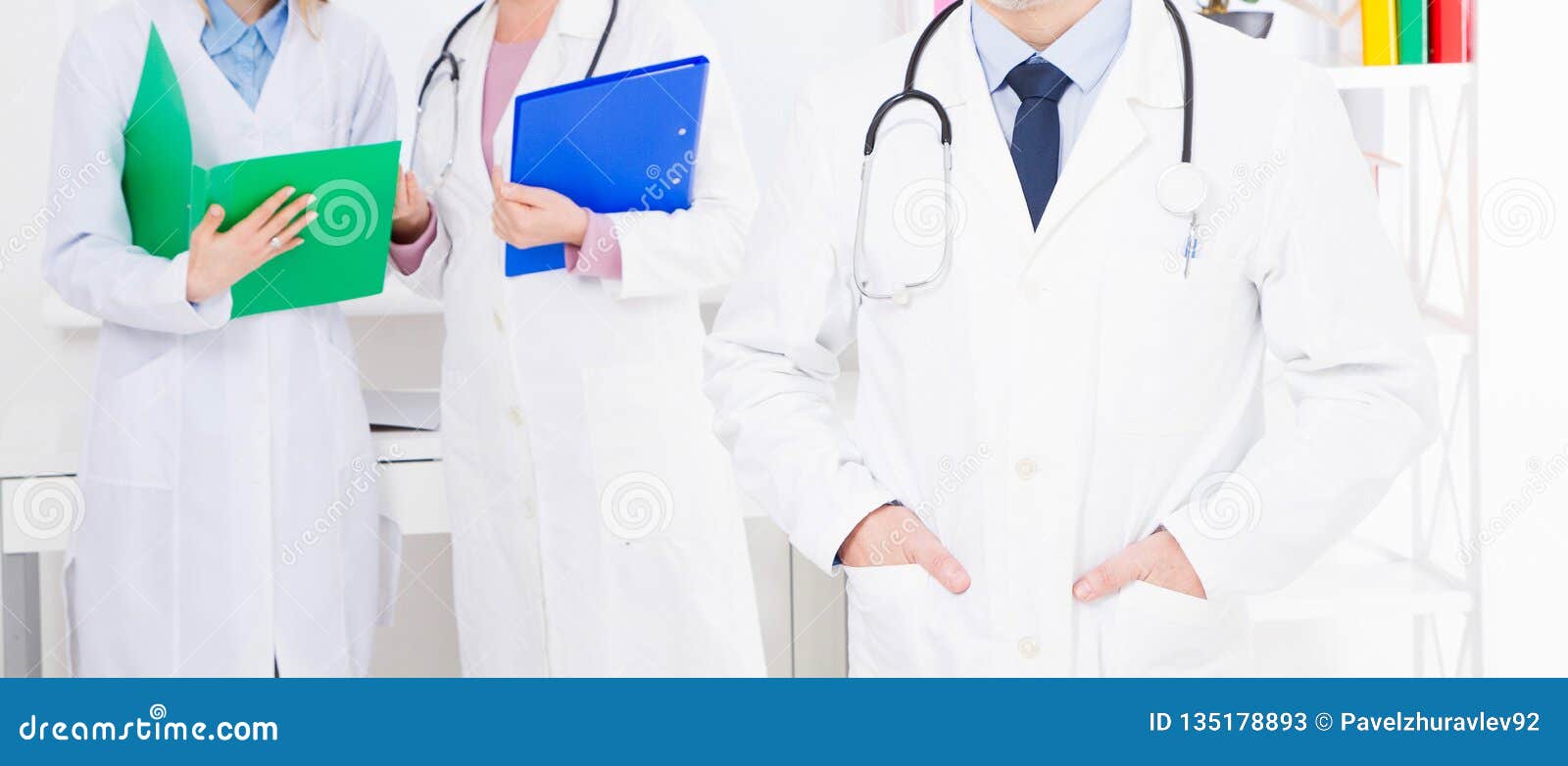 Doctor Posing in Office with Medical Staff Stock Image - Image of ...