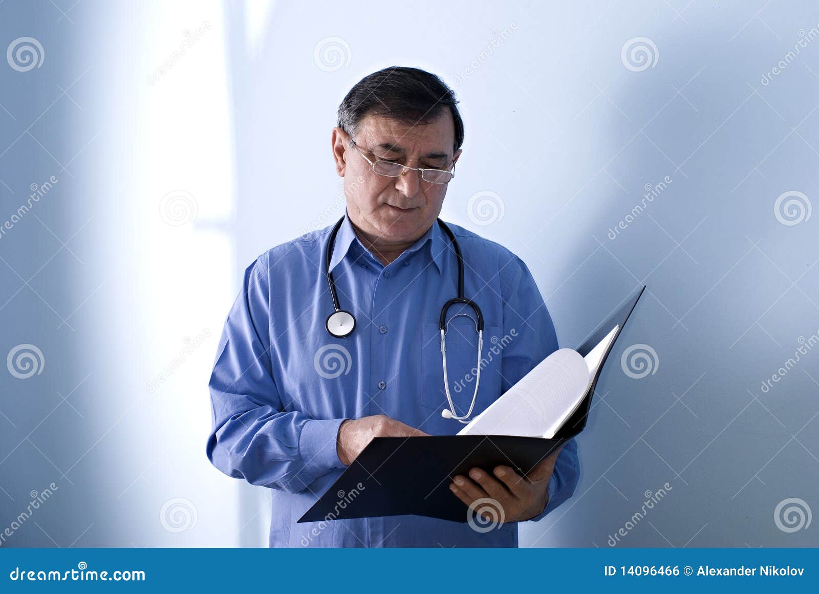 Doctor reading case notes stock photo. Image of physician - 14096466