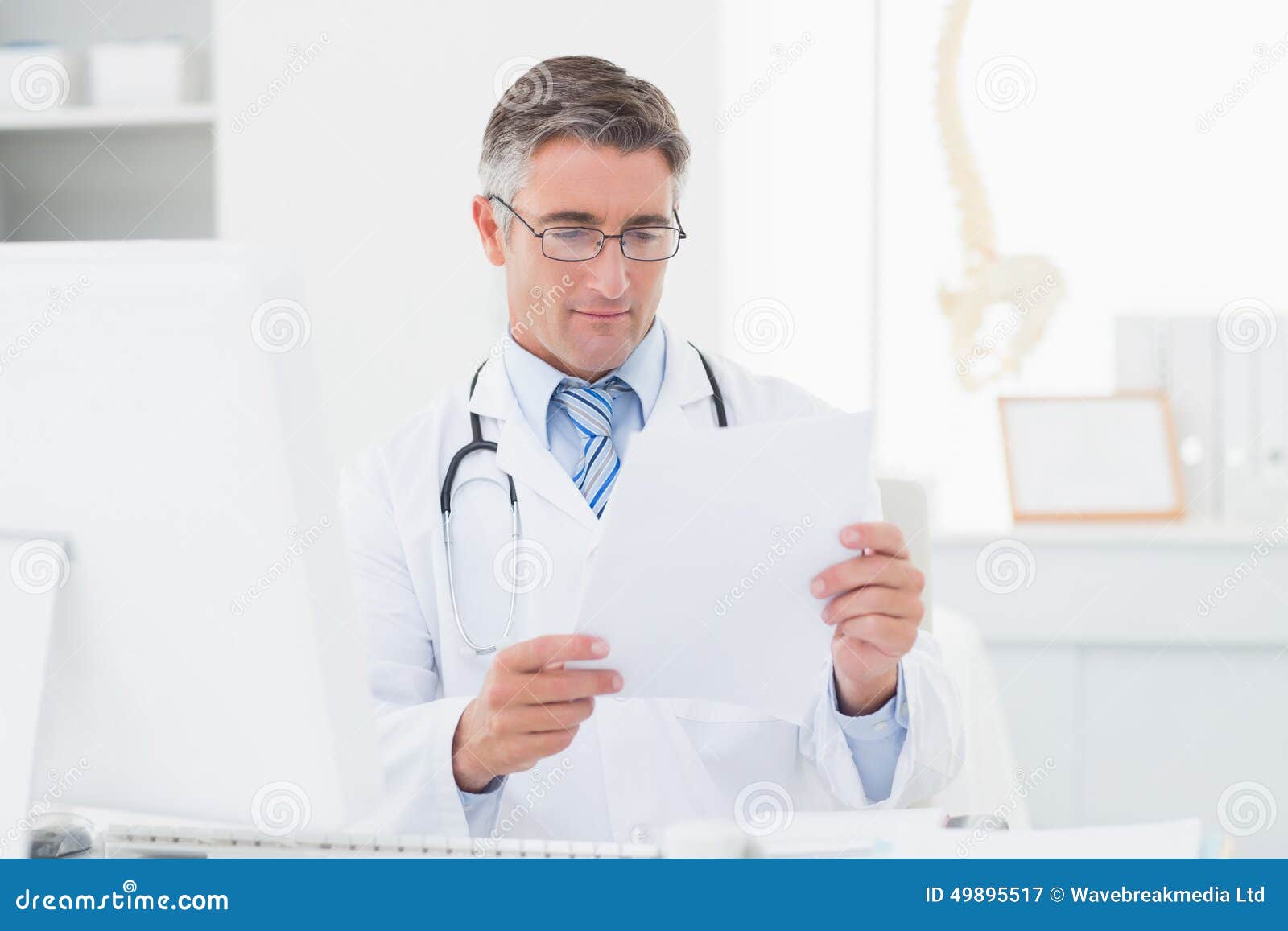 Doctor Reading Document in Clinic Stock Image - Image of coat, doctor ...