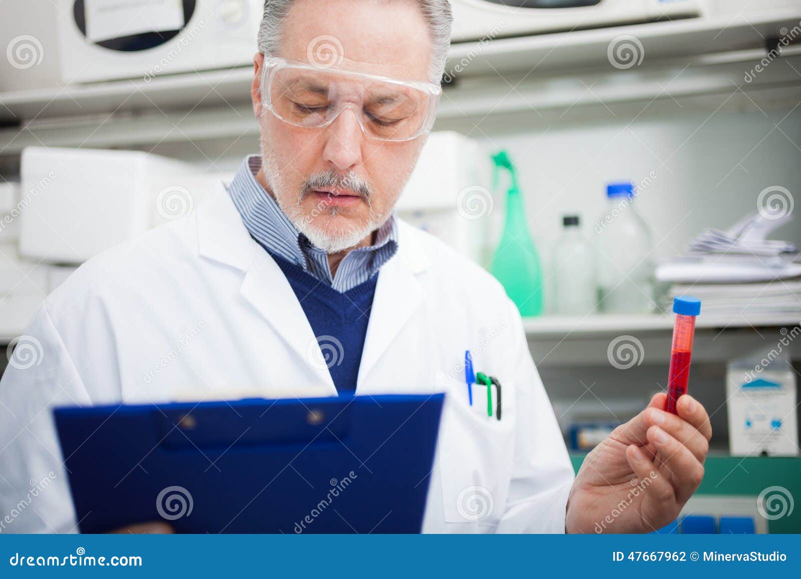Doctor Reading a Document while Holding a Test Tube Stock Photo - Image ...