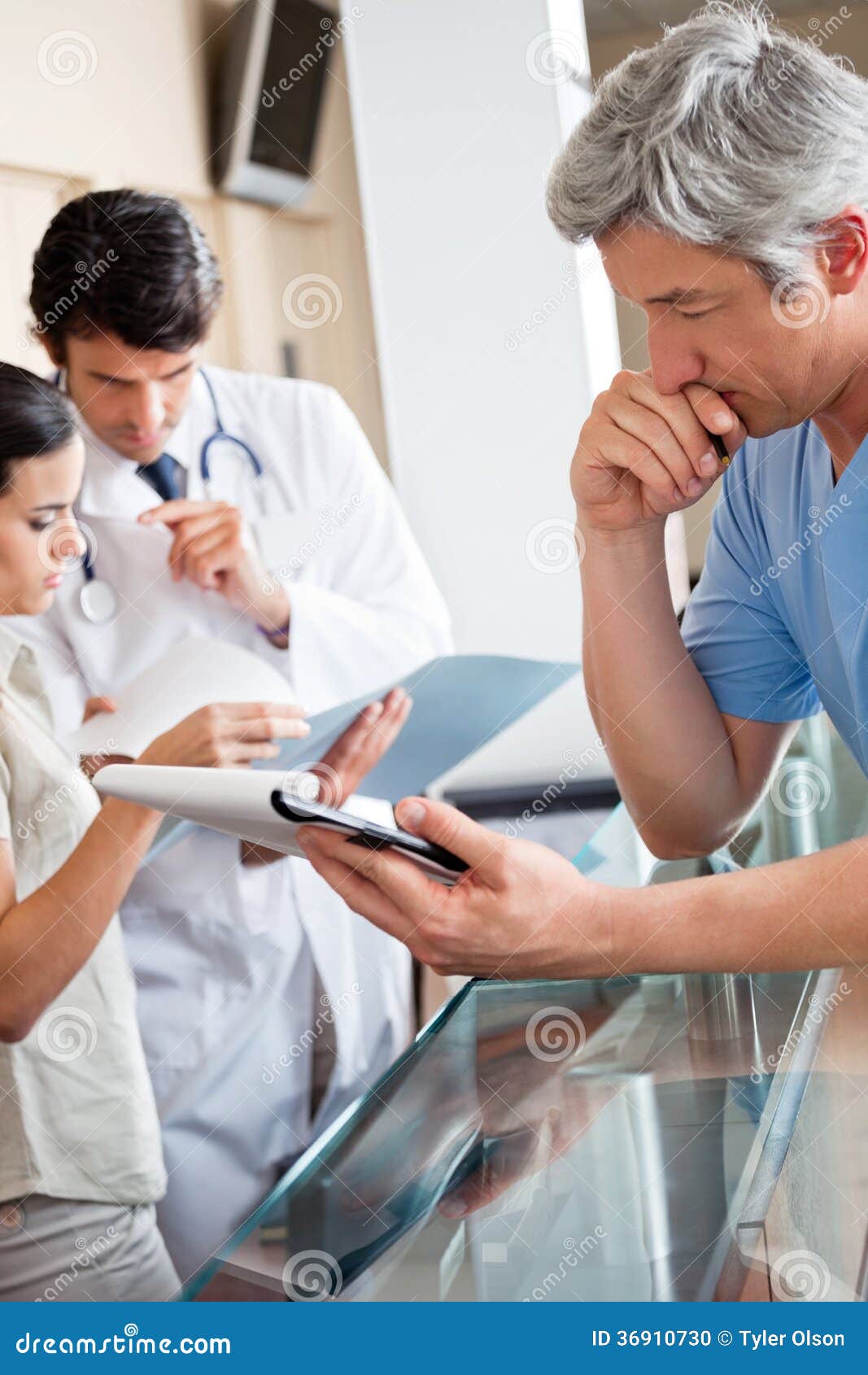 Doctor Reading Document at Reception Stock Photo - Image of expertise ...