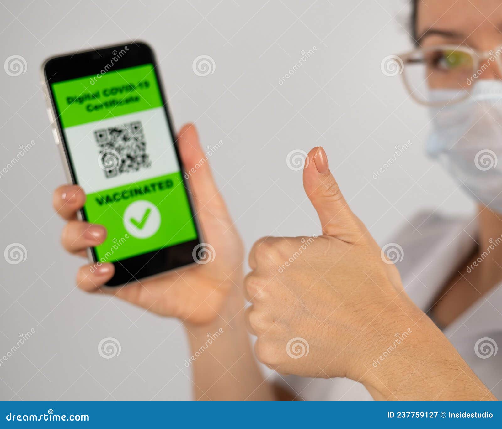 The Doctor Recommends Vaccination and Holds a Smartphone with a QR Code ...