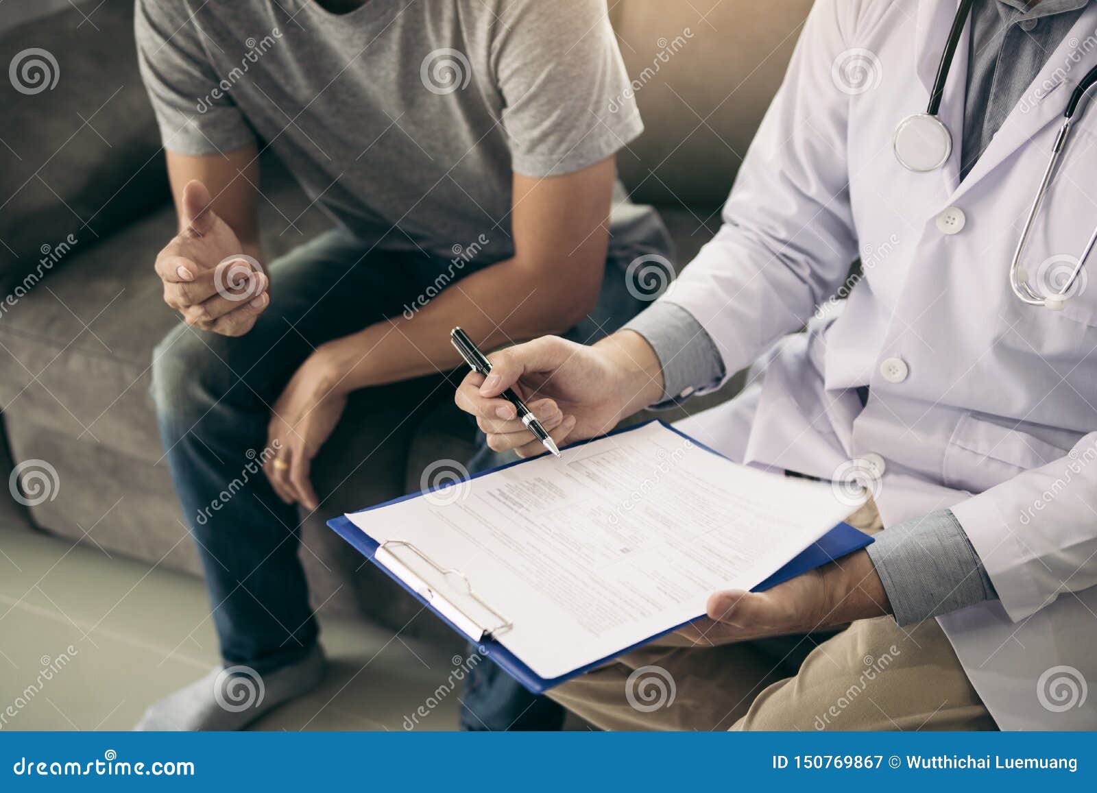 Doctor is Recording the Patient`s Information while the Patient is ...