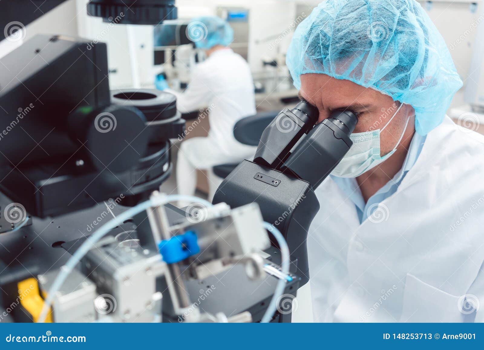 Doctor or Scientist Looking Thru Microscope in Lab Stock Image - Image ...