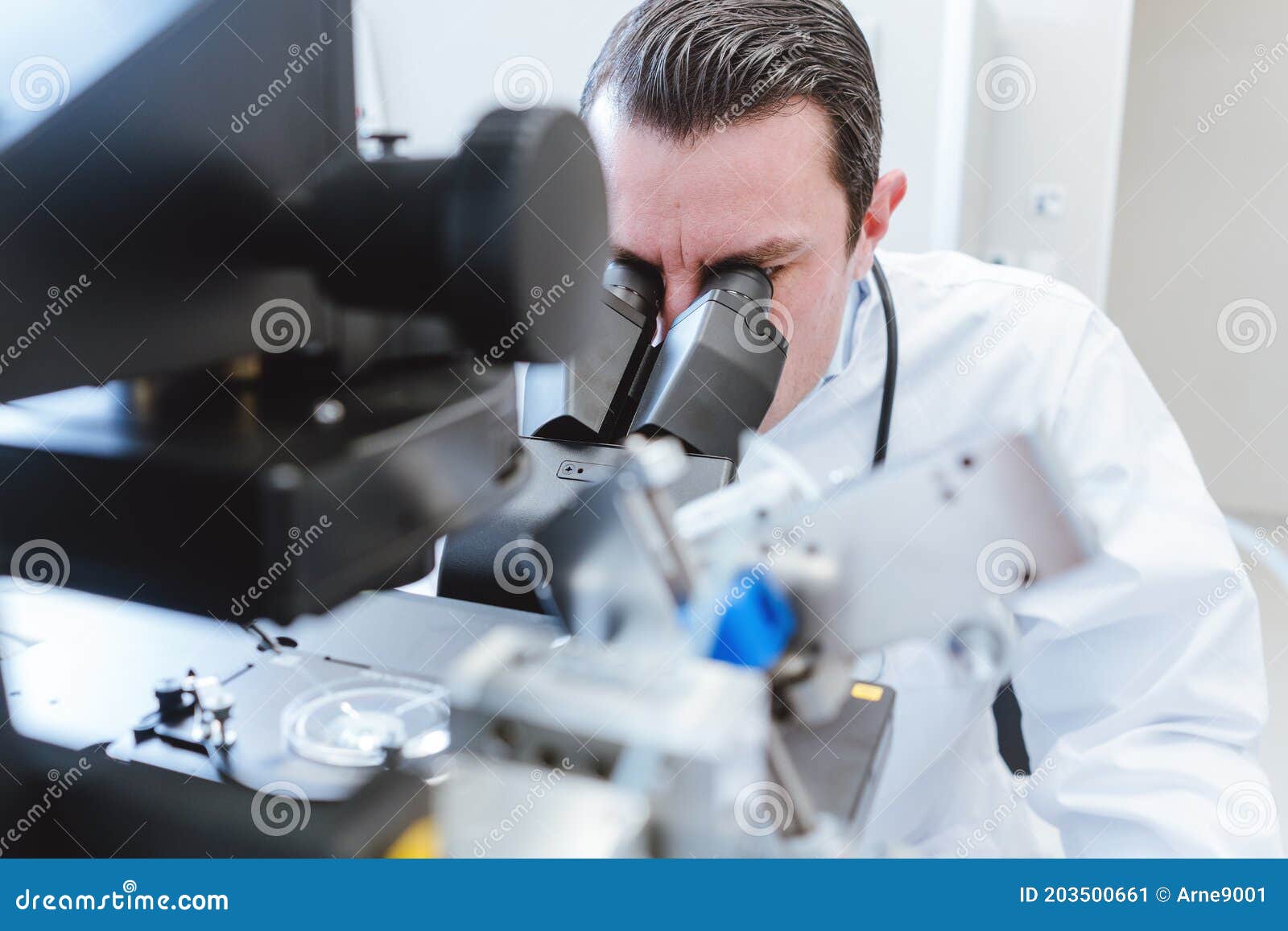 Doctor or Scientist Looking Thru Microscope in Lab Stock Image - Image ...