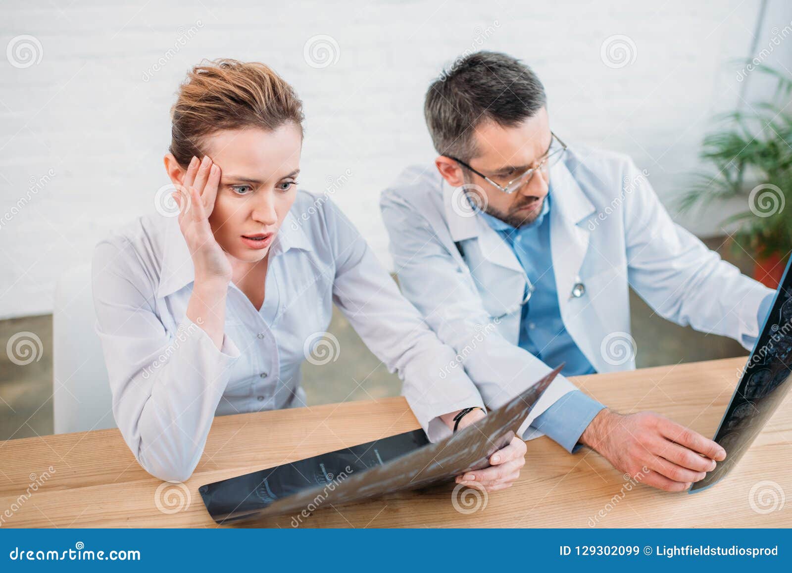 Doctor and Shocked Patient Examining Stock Image - Image of people ...