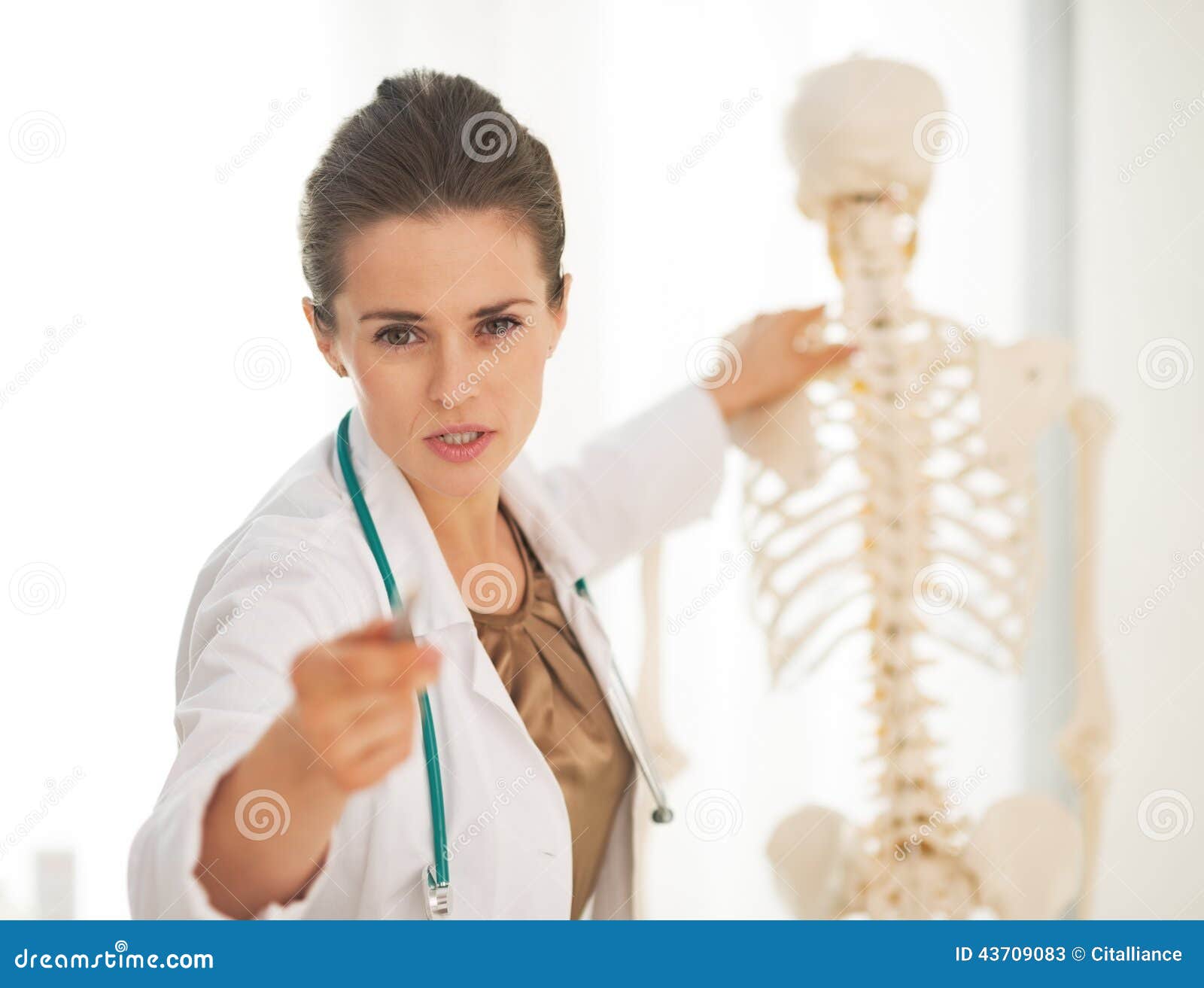 Doctor Showing on Spine and Pointing in Camera Stock Image - Image of ...