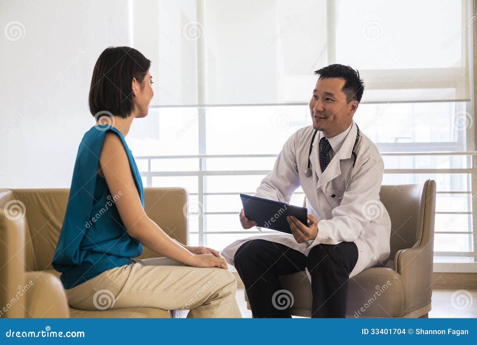 Doctor Sitting Down and Consulting Patient in the Hospital Stock Photo ...