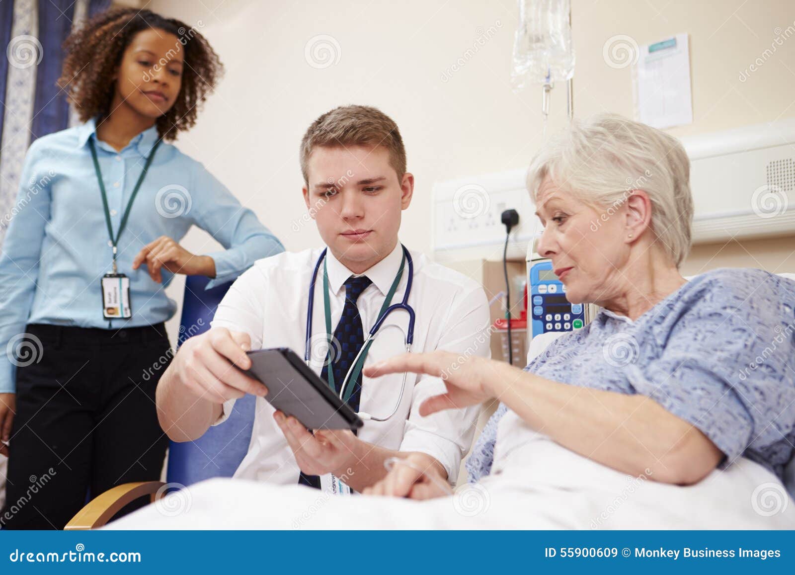 Doctor Sitting by Female Patient S Bed Using Digital Tablet Stock Image ...