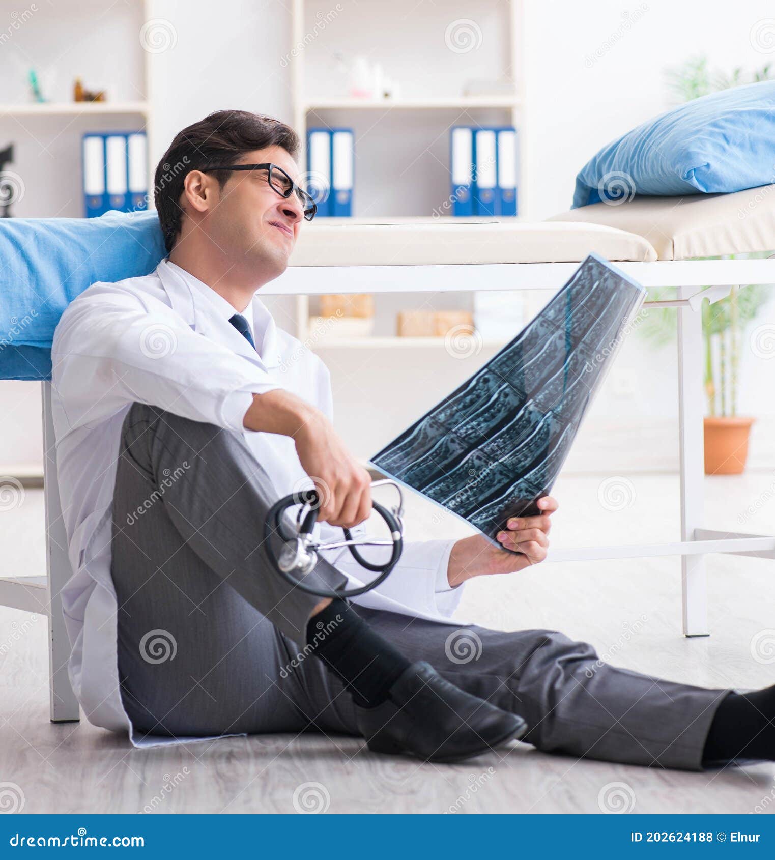 Doctor Sitting on the Floor in Hospital Stock Photo - Image of sitting ...
