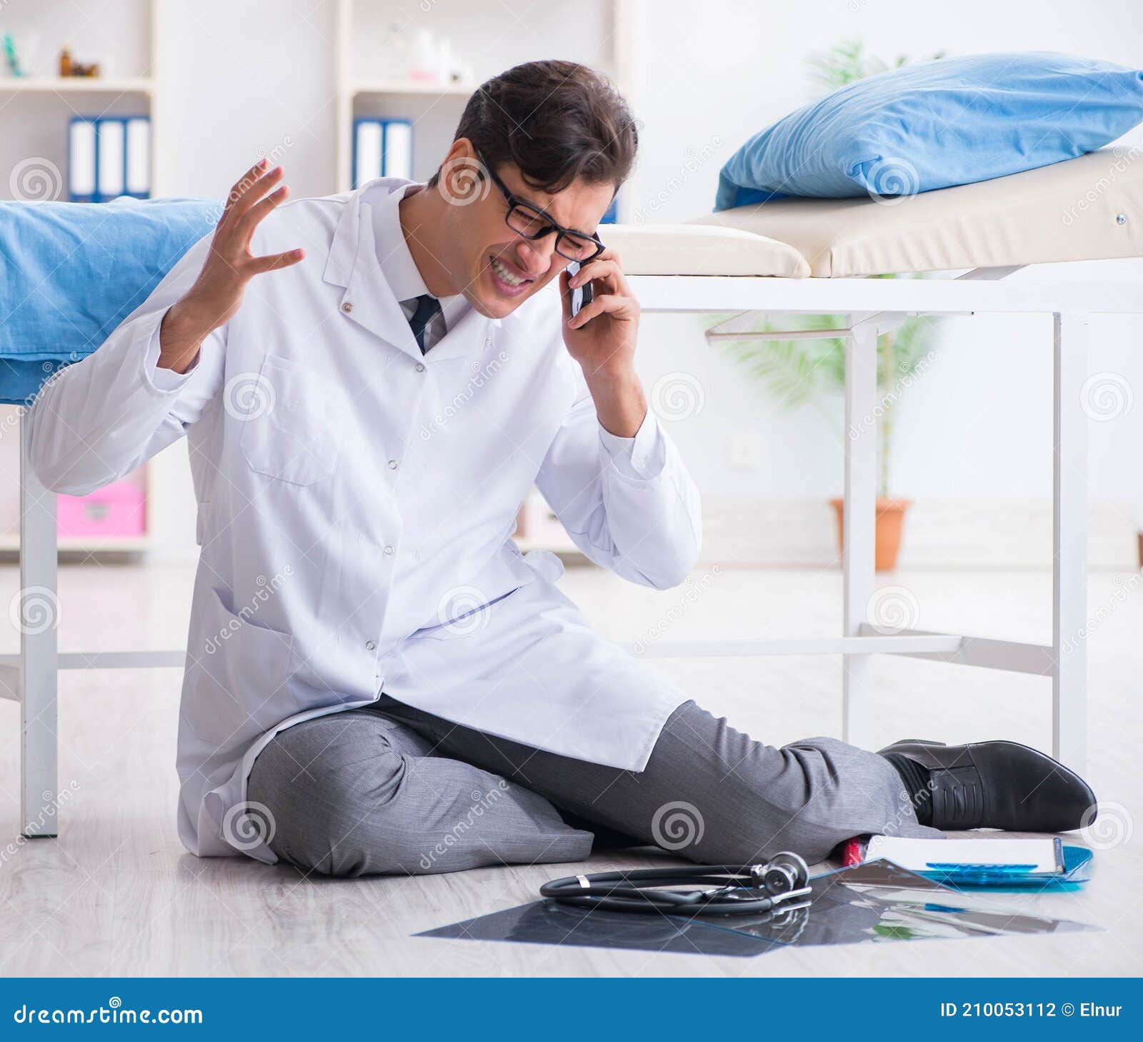 Doctor Sitting on the Floor in Hospital Stock Photo - Image of mobile ...