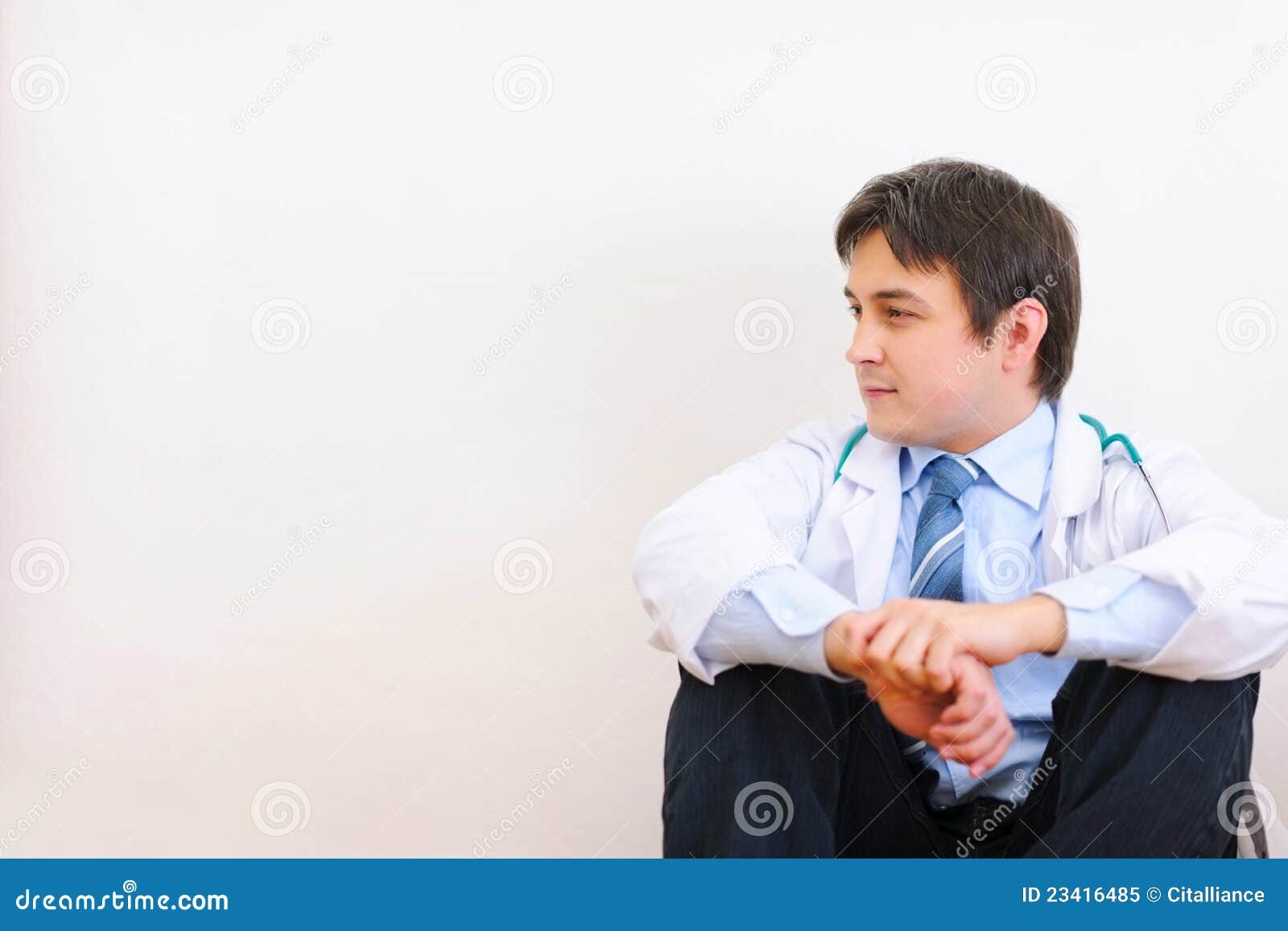 Doctor Sitting on Floor and Looking on Corner Stock Image - Image of ...