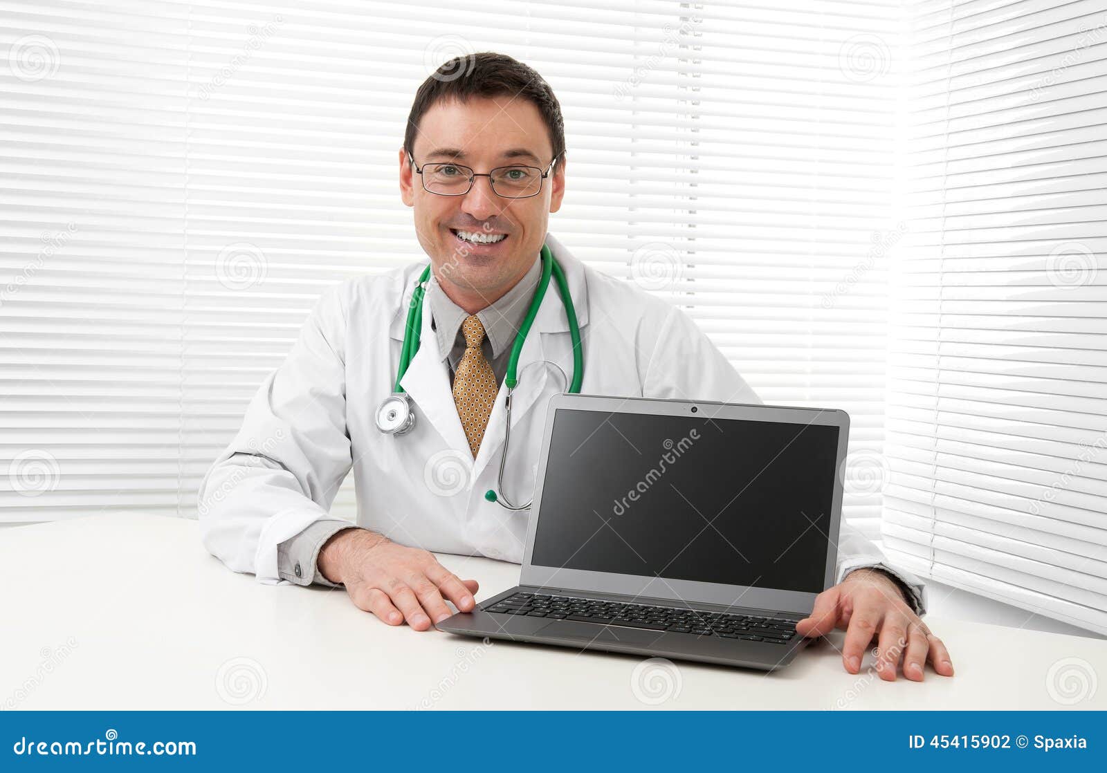 Doctor Sitting at His Desk with Laptop Stock Photo - Image of ...