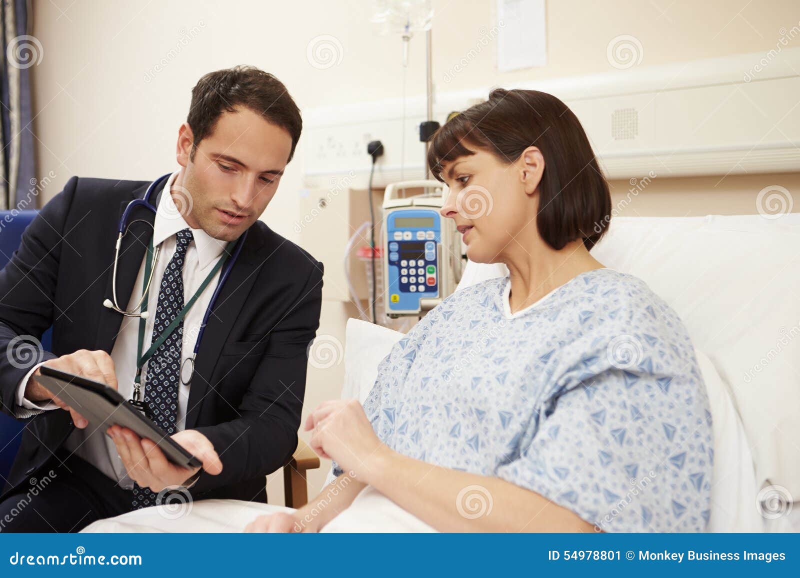 Doctor Sitting by Male Patient S Bed Using Digital Tablet Stock Image ...