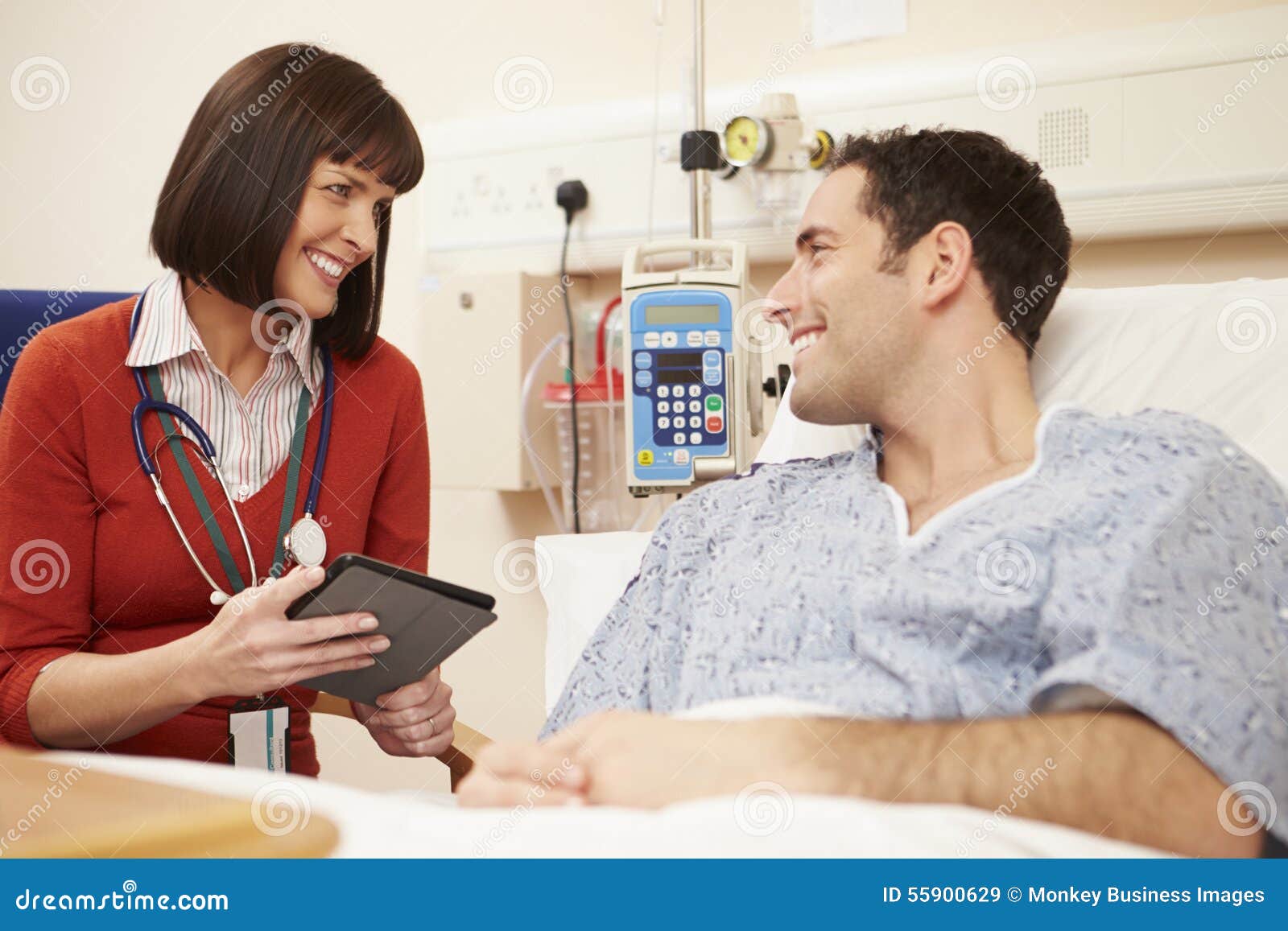 Doctor Sitting by Male Patient S Bed Using Digital Tablet Stock Image ...