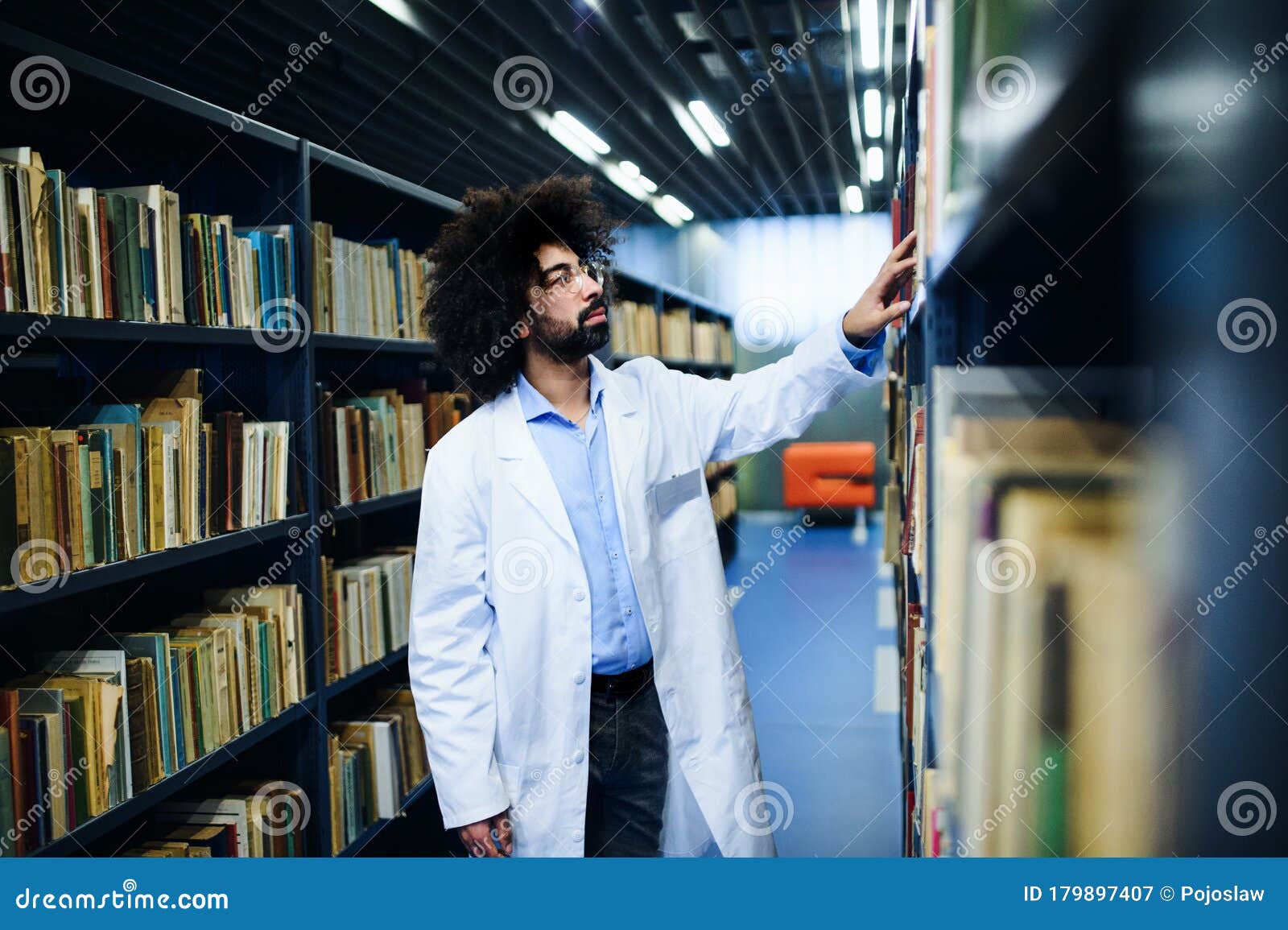 Doctor Standing in Library, Looking for a Book on Shelf. Stock Image ...