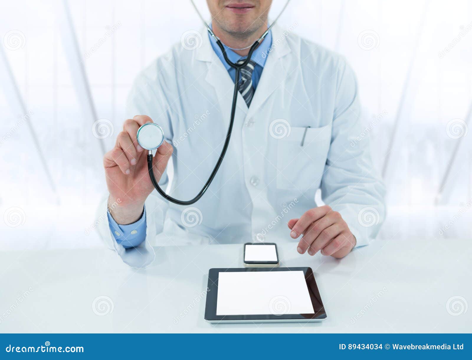 Doctor With Stethoscope And Devices At Desk Against Blurry Window Stock ...