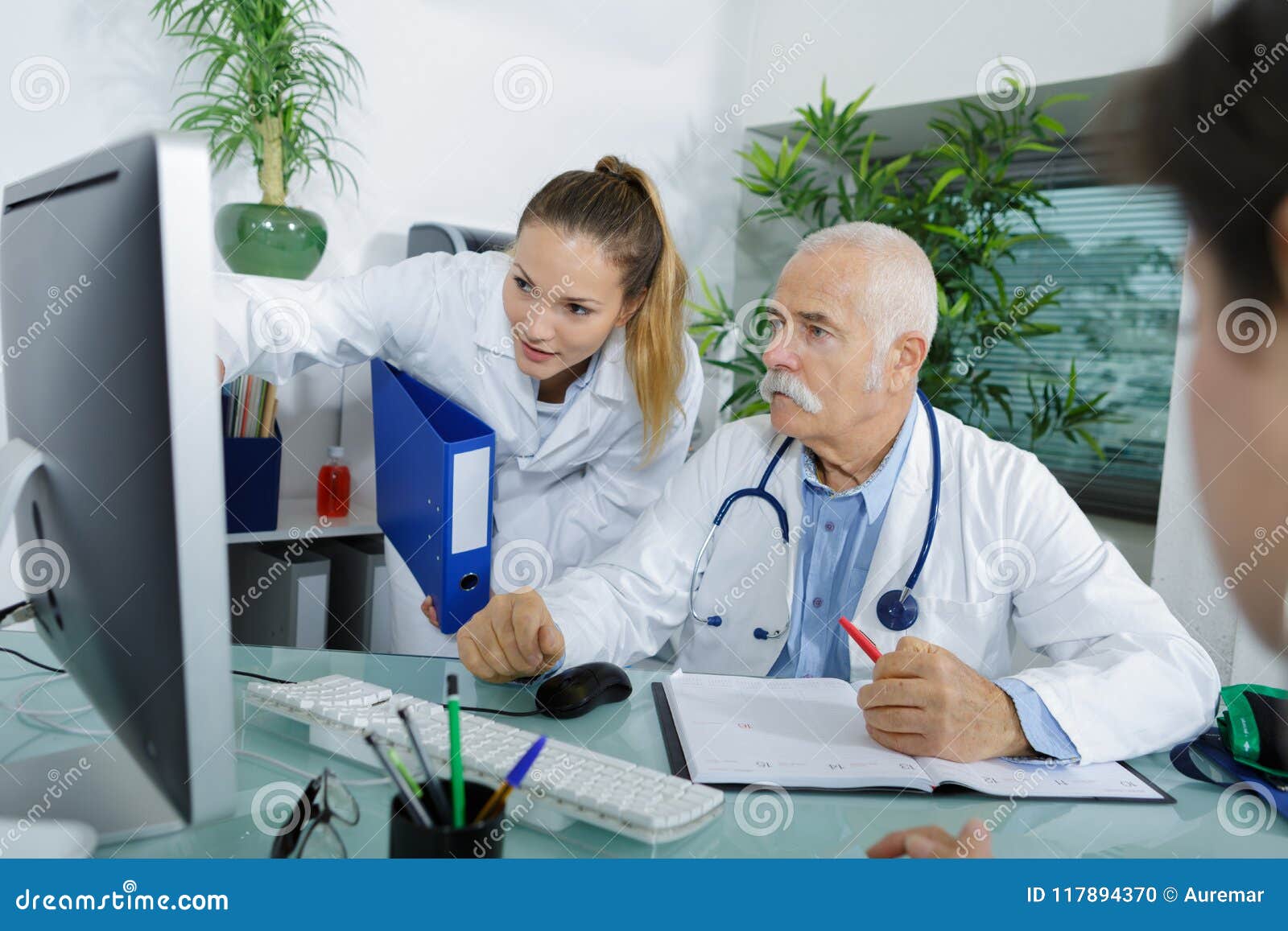 Doctor and Student Looking at Computer Screen Stock Photo - Image of ...