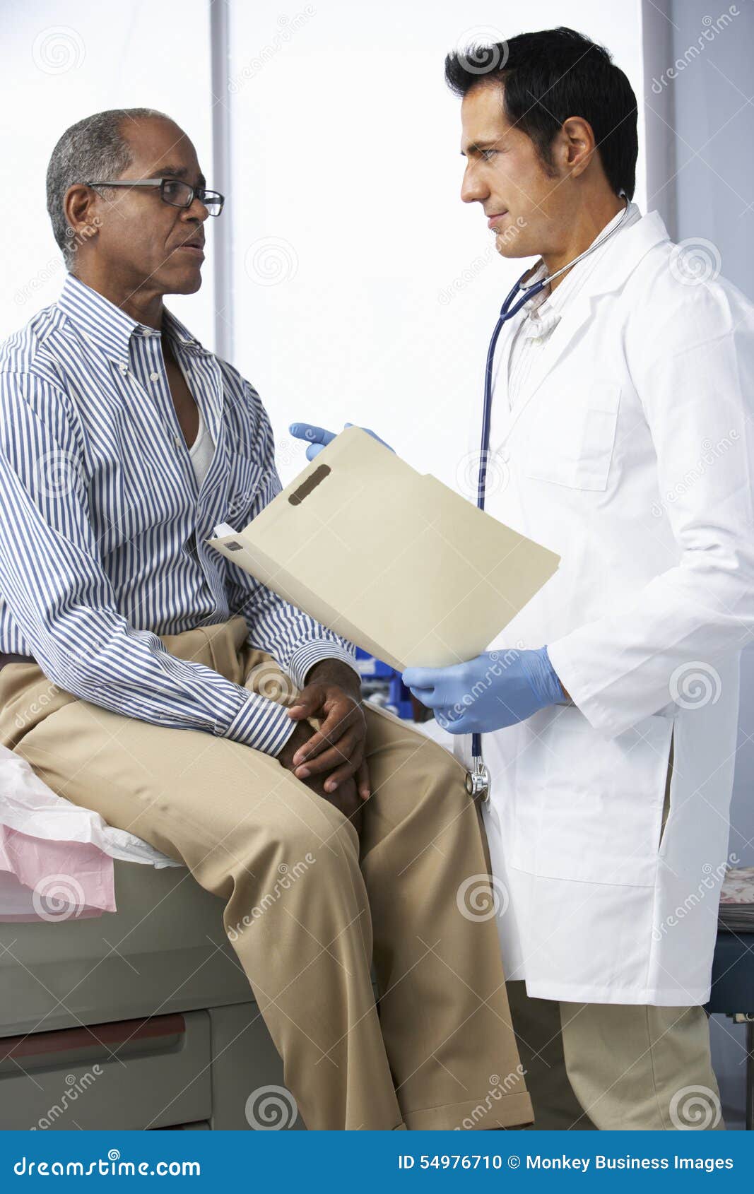 Doctor in Surgery with Male Patient Reading Notes Stock Photo - Image ...