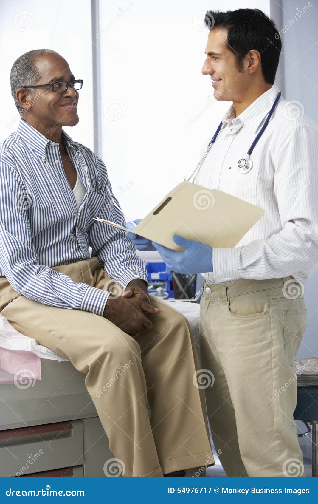 Doctor in Surgery with Male Patient Reading Notes Stock Image - Image ...