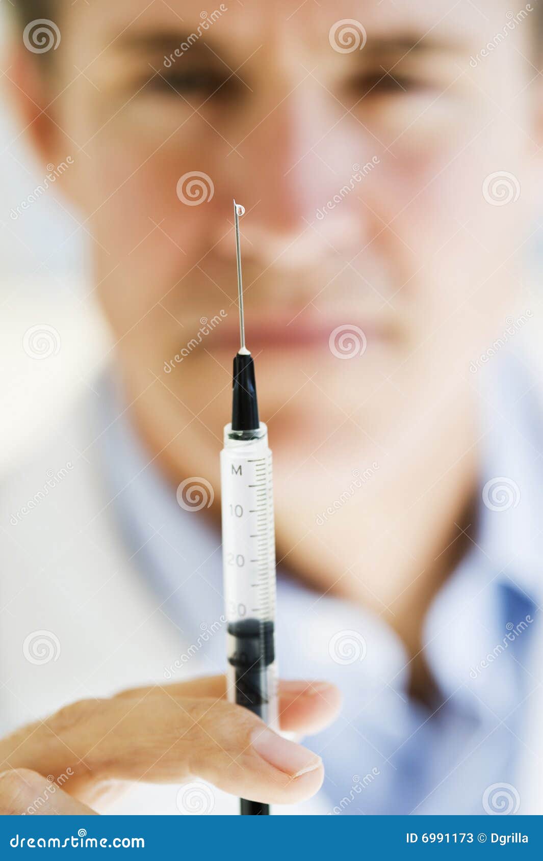 Doctor with syringe stock image. Image of concentrated - 6991173