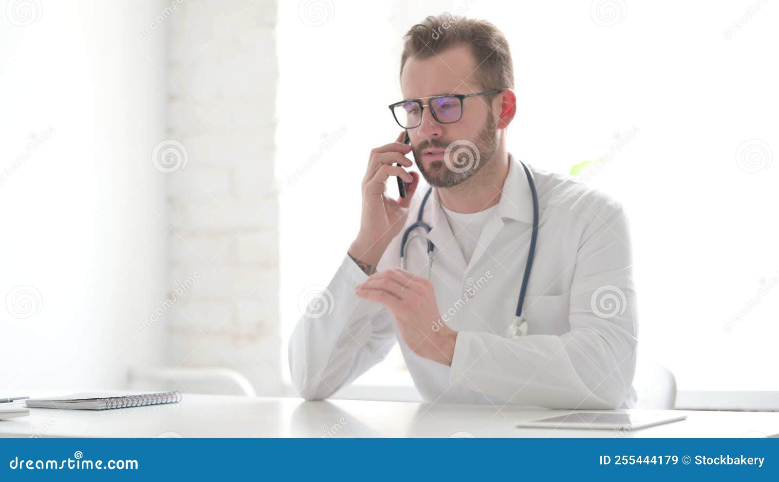Doctor Talking on Phone in Clinic Stock Image - Image of smiling ...