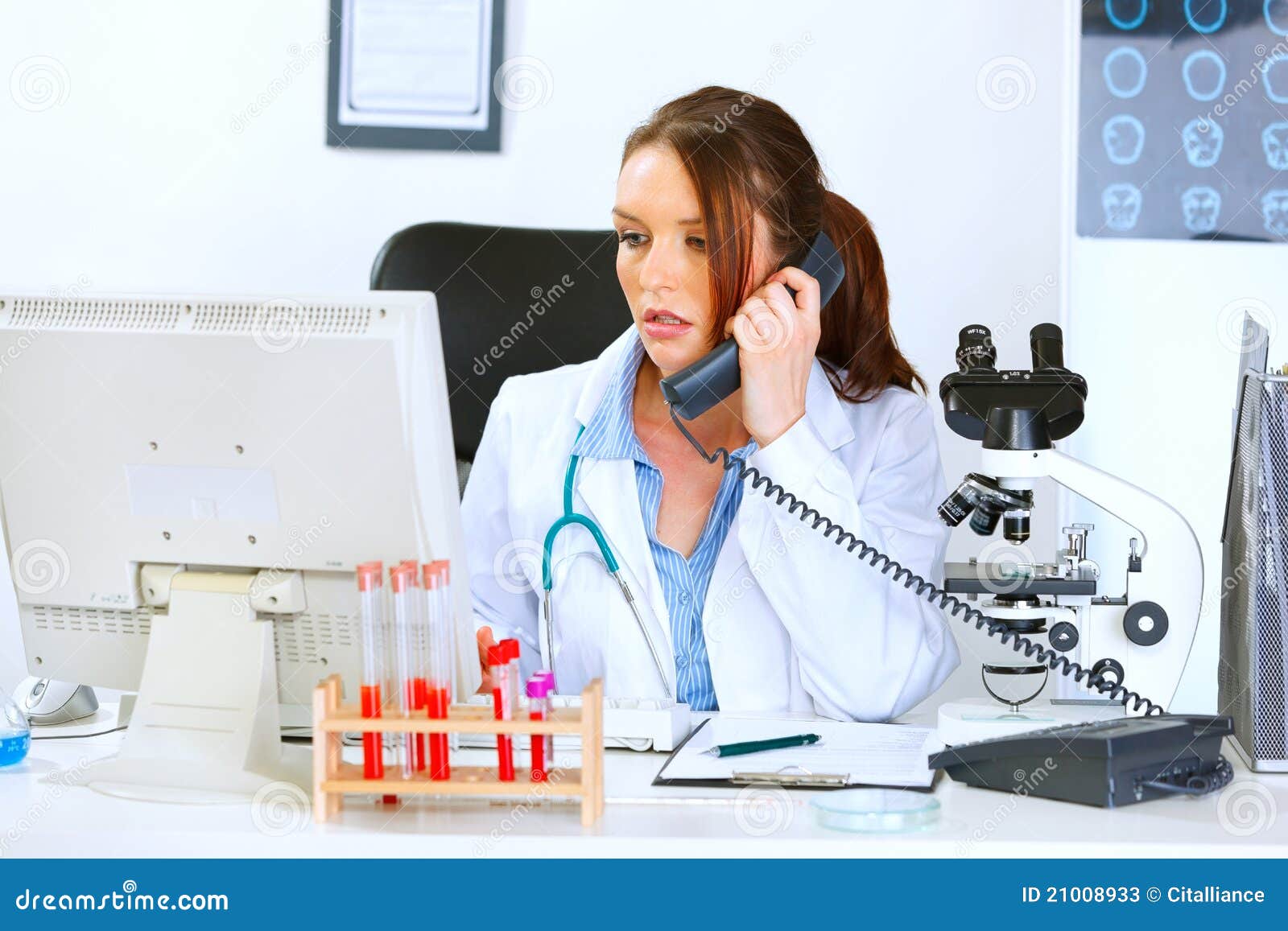 Doctor Talking on Phone and Looking in Monitor Stock Image - Image of ...
