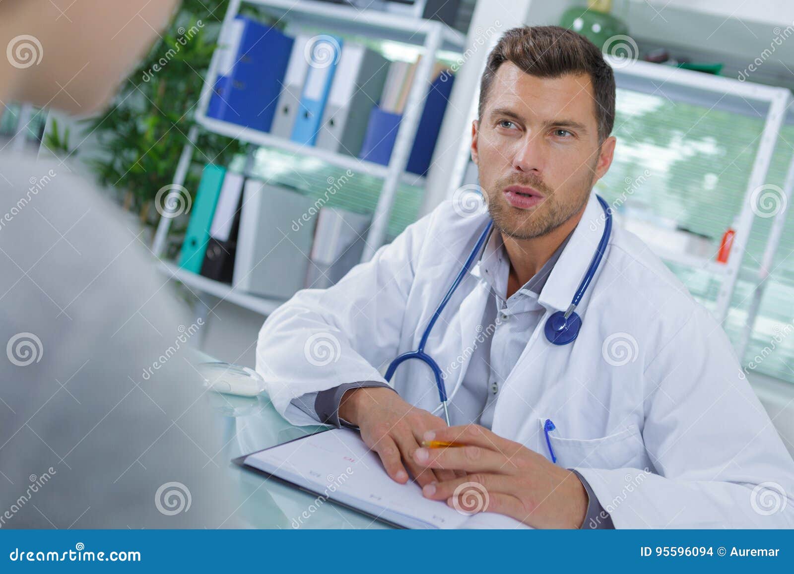 Doctor Talking To Patient during Visit Stock Photo - Image of service ...