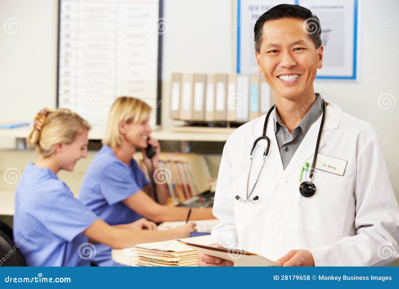 Doctor with Two Nurses Working at Nurses Station Stock Photo - Image of ...