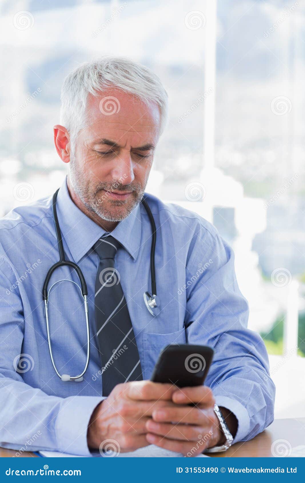 Doctor Typing a Text Message on His Smartphone Stock Photo - Image of ...