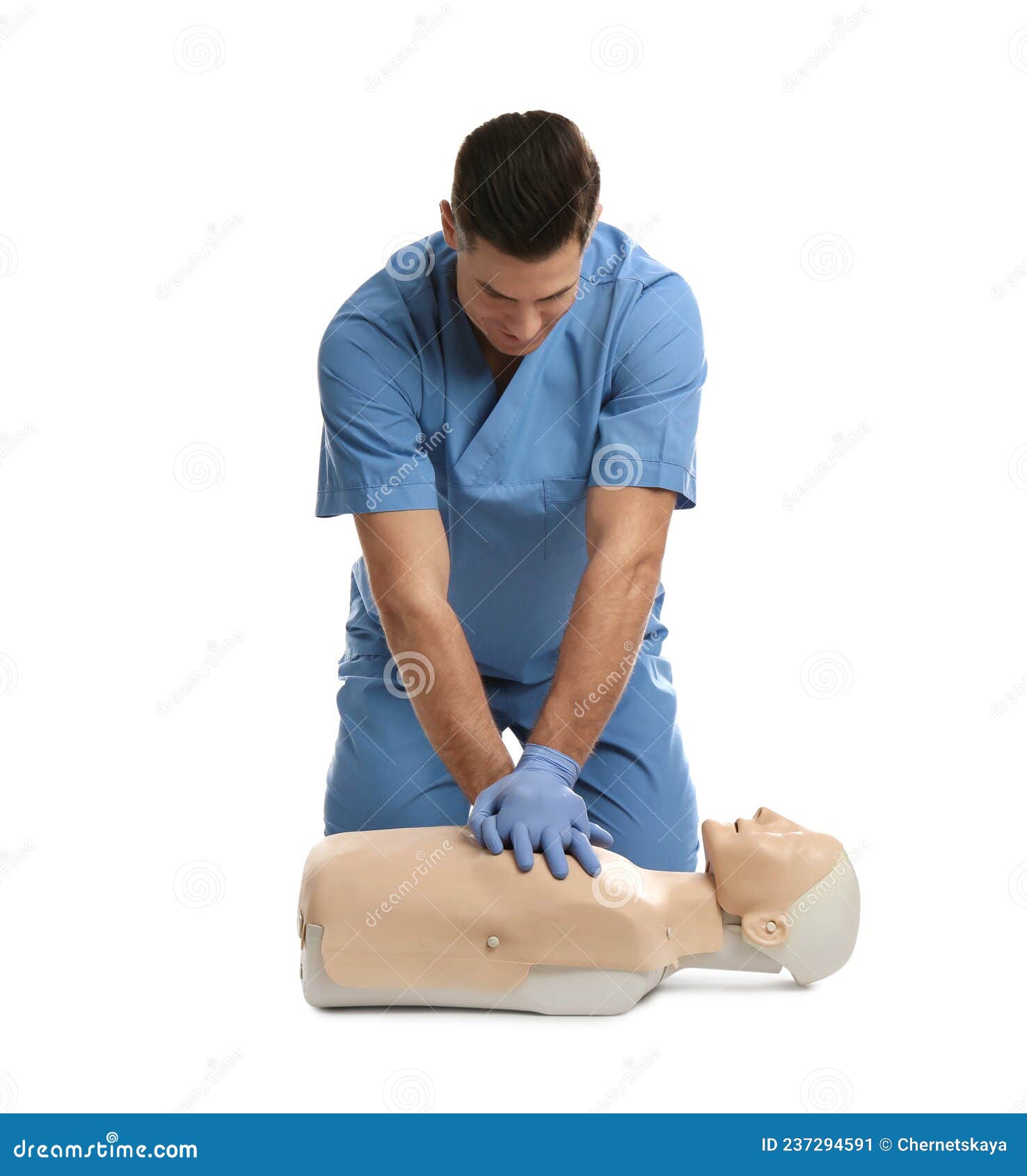 Doctor in Uniform Practicing First Aid on Mannequin Against White ...