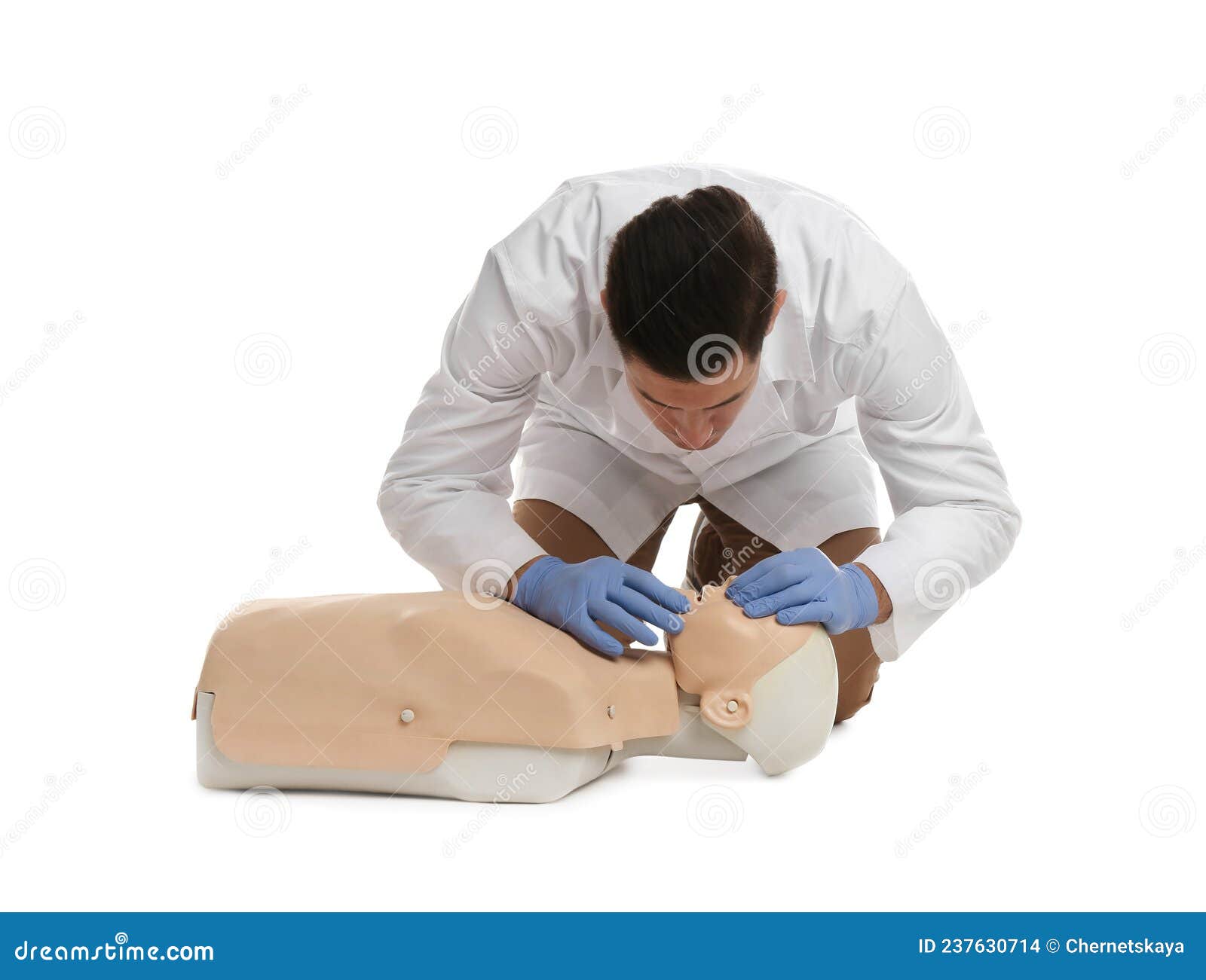 Doctor in Uniform Practicing First Aid on Mannequin Against White ...