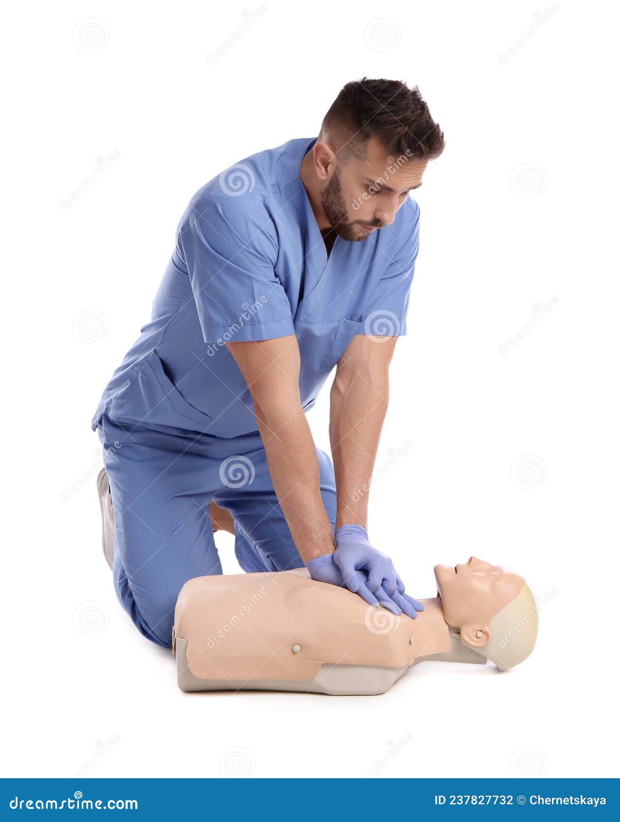 Doctor in Uniform Practicing First Aid on Mannequin Against White ...